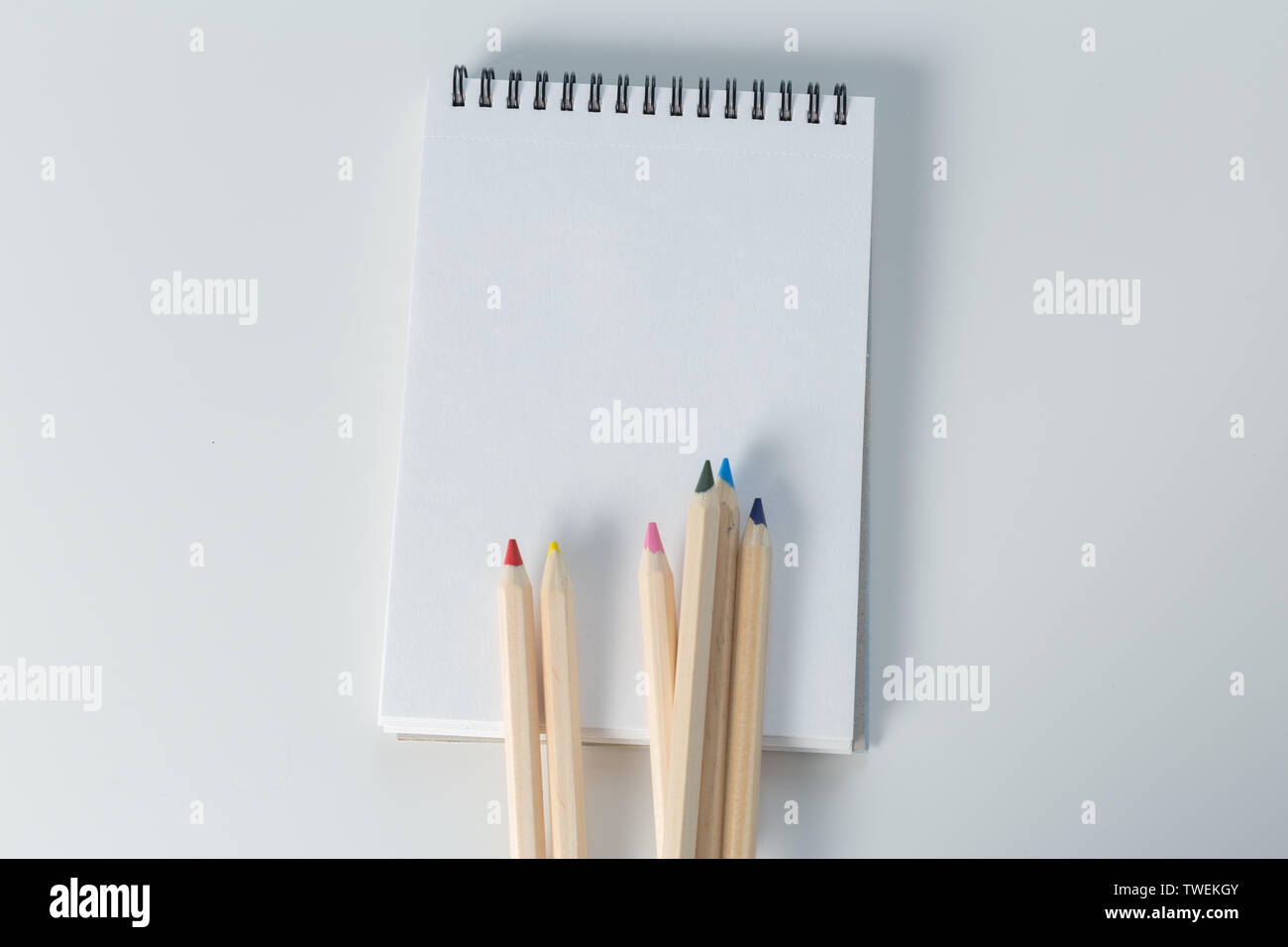 Color pencil and sketchbook on a table Stock Photo - Alamy