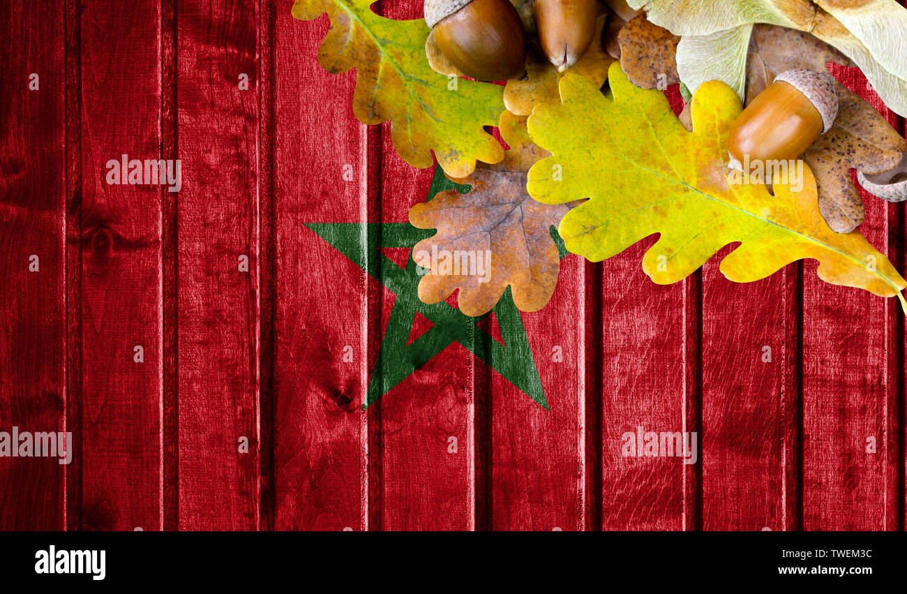 Morocco flag on autumn wooden background with leaves and good place for ...
