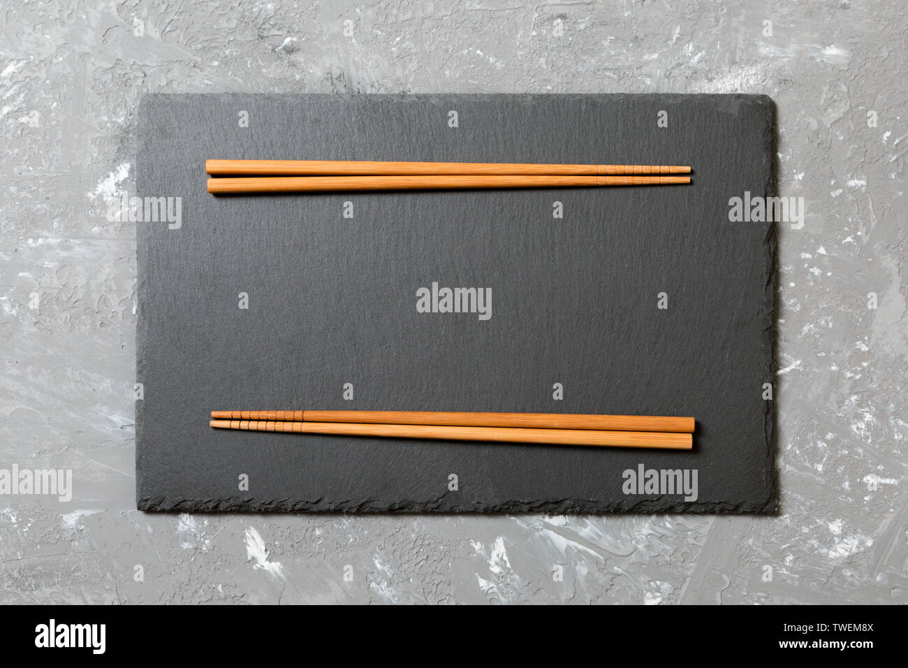 rectangular slate plate with chopsticks for sushi on black marble ...