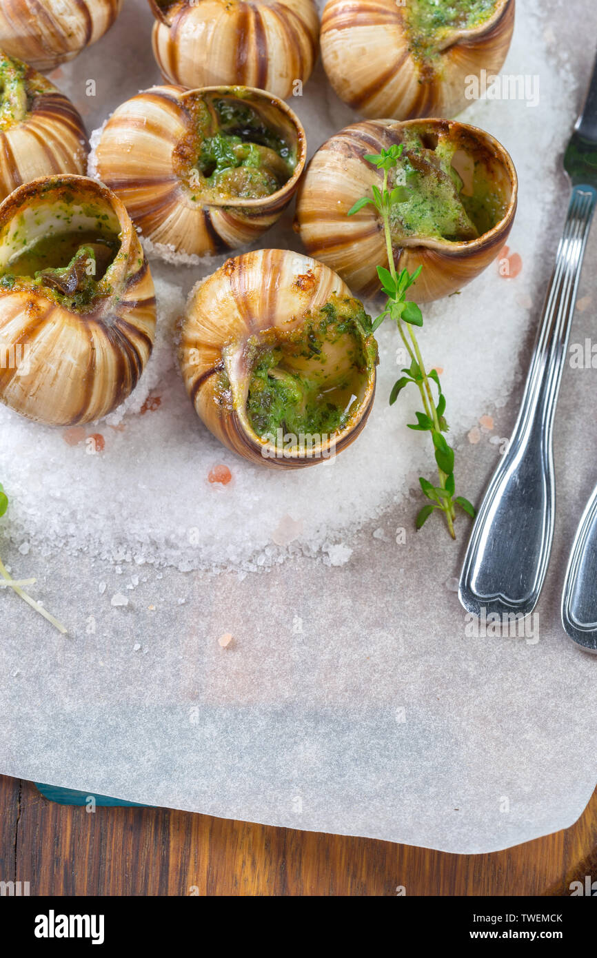Baked snails with garlic butter and fresh herbs Stock Photo - Alamy