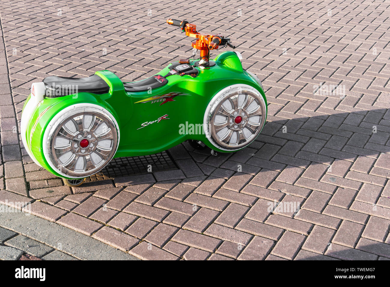 green mini toy car with silver colored rims parked on the street Stock ...