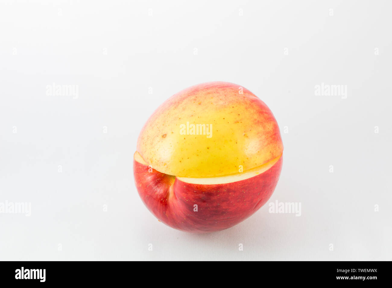 A red apple cut into two halves and articulate Stock Photo - Alamy