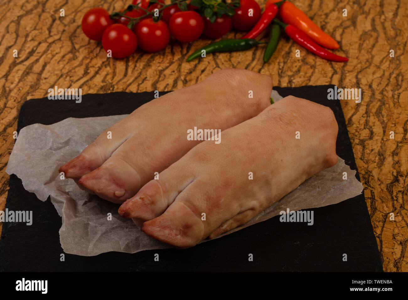 Raw pig's hoof ower wooden background Stock Photo - Alamy
