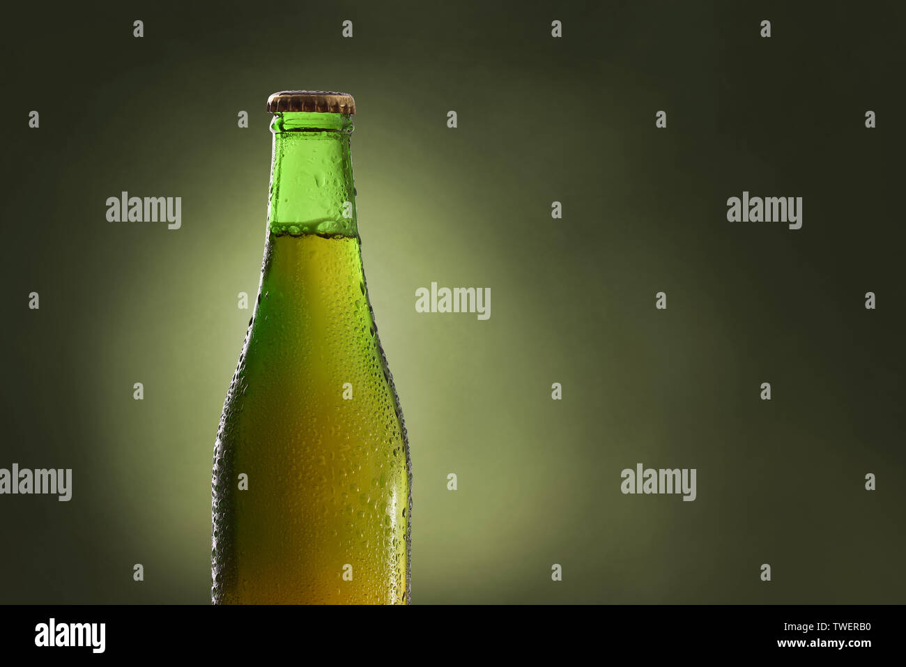 Bottle full of liquid with alcohol with green background close up ...