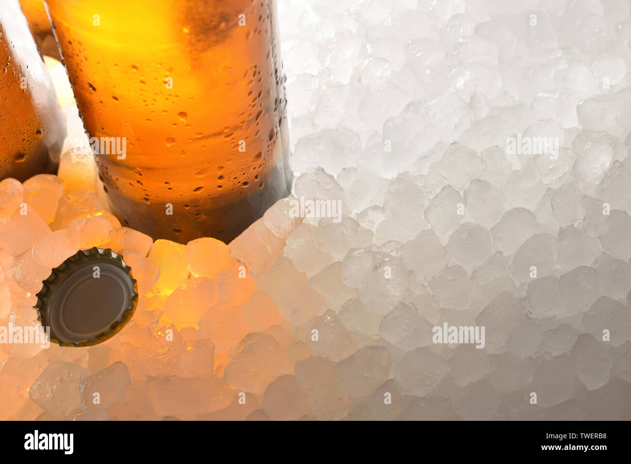 Beer glass bottles on ice with cap . Horizontal composition. Elevated ...