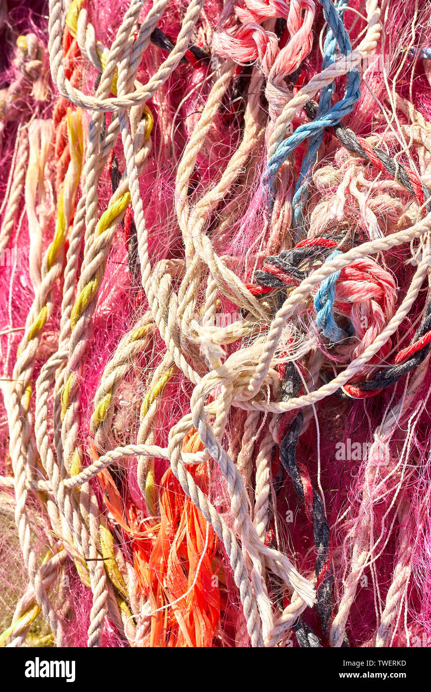 A tangled mess of fishing nets plastic rope and other debris washed up ...