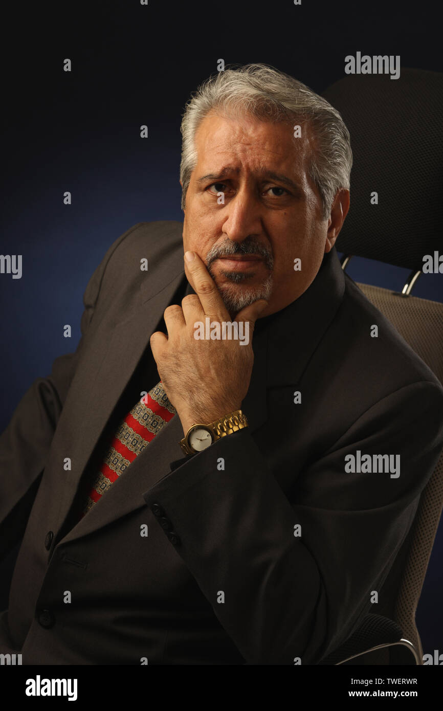 Portrait of a businessman thinking Stock Photo - Alamy