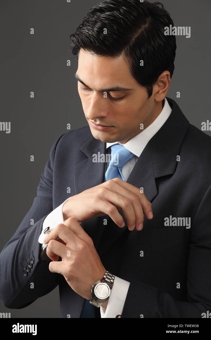 Businessman adjusting cuffs hi-res stock photography and images - Alamy