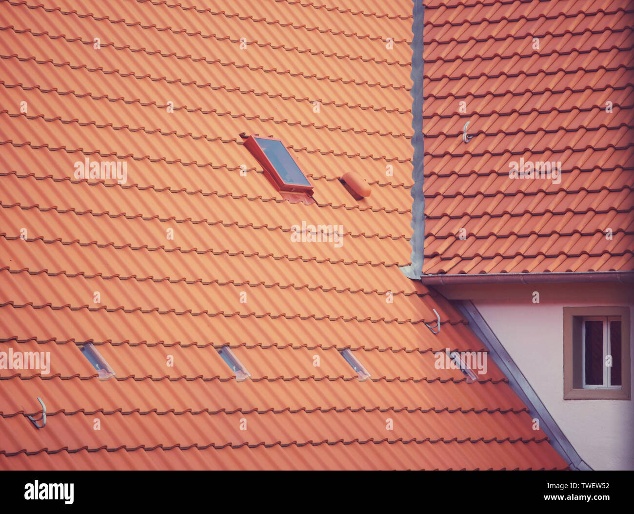 Modern European rooftop with tiles and windows Stock Photo - Alamy