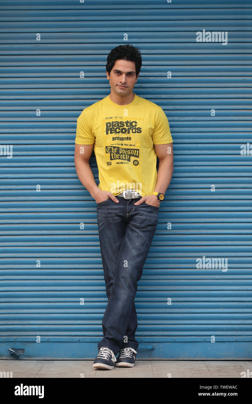 Portrait of a man standing against a shutter Stock Photo - Alamy