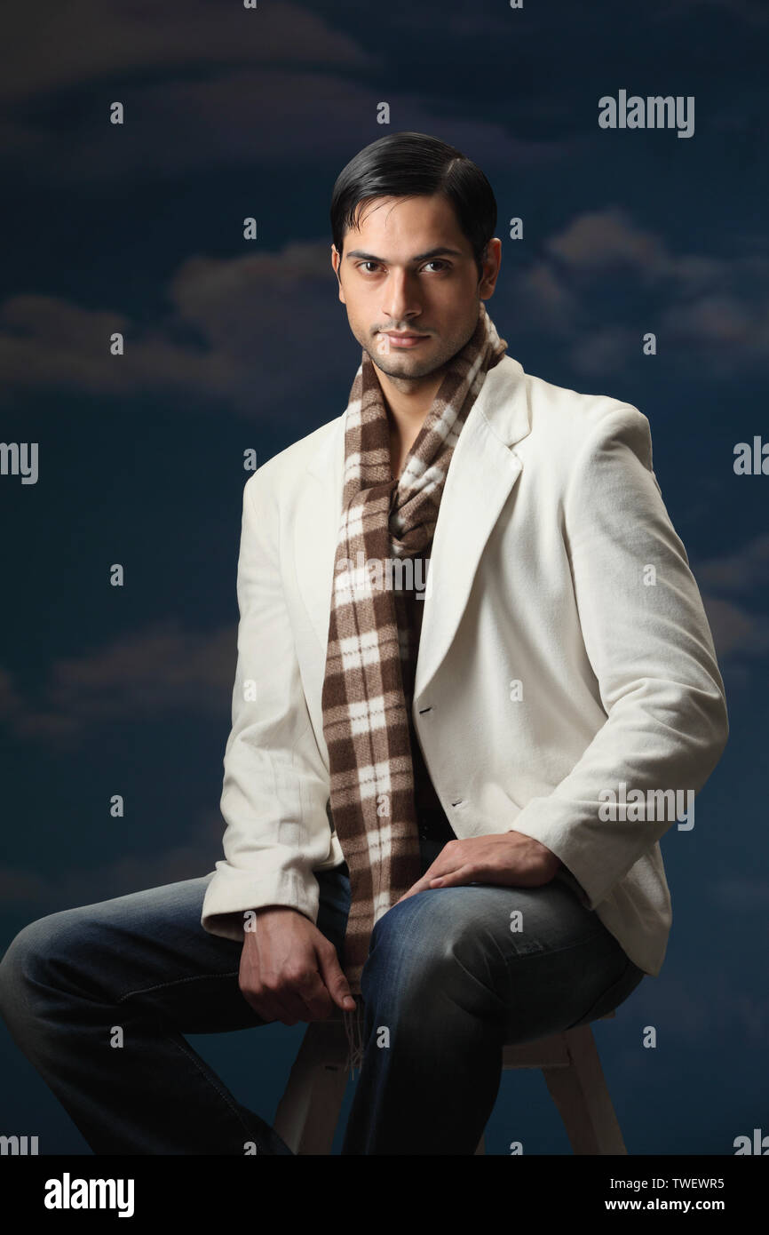 Portrait of a man sitting on a stool Stock Photo - Alamy