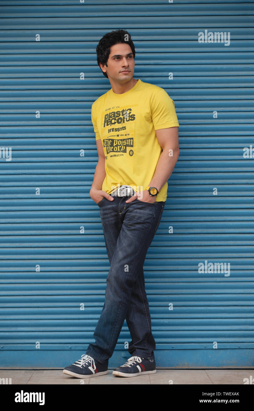 Man standing against a shutter Stock Photo - Alamy