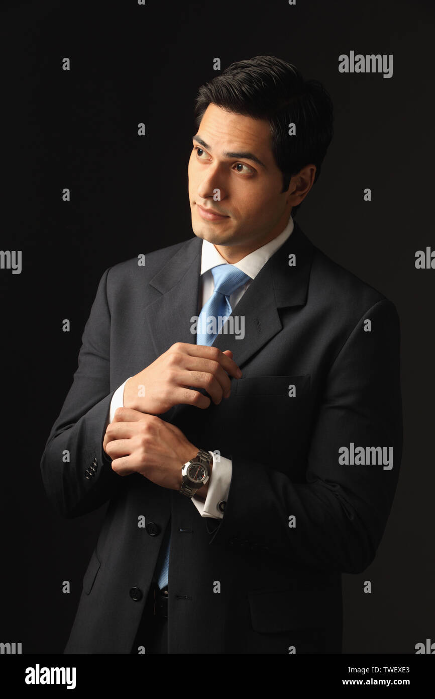 Businessman adjusting cuffs hi-res stock photography and images - Alamy