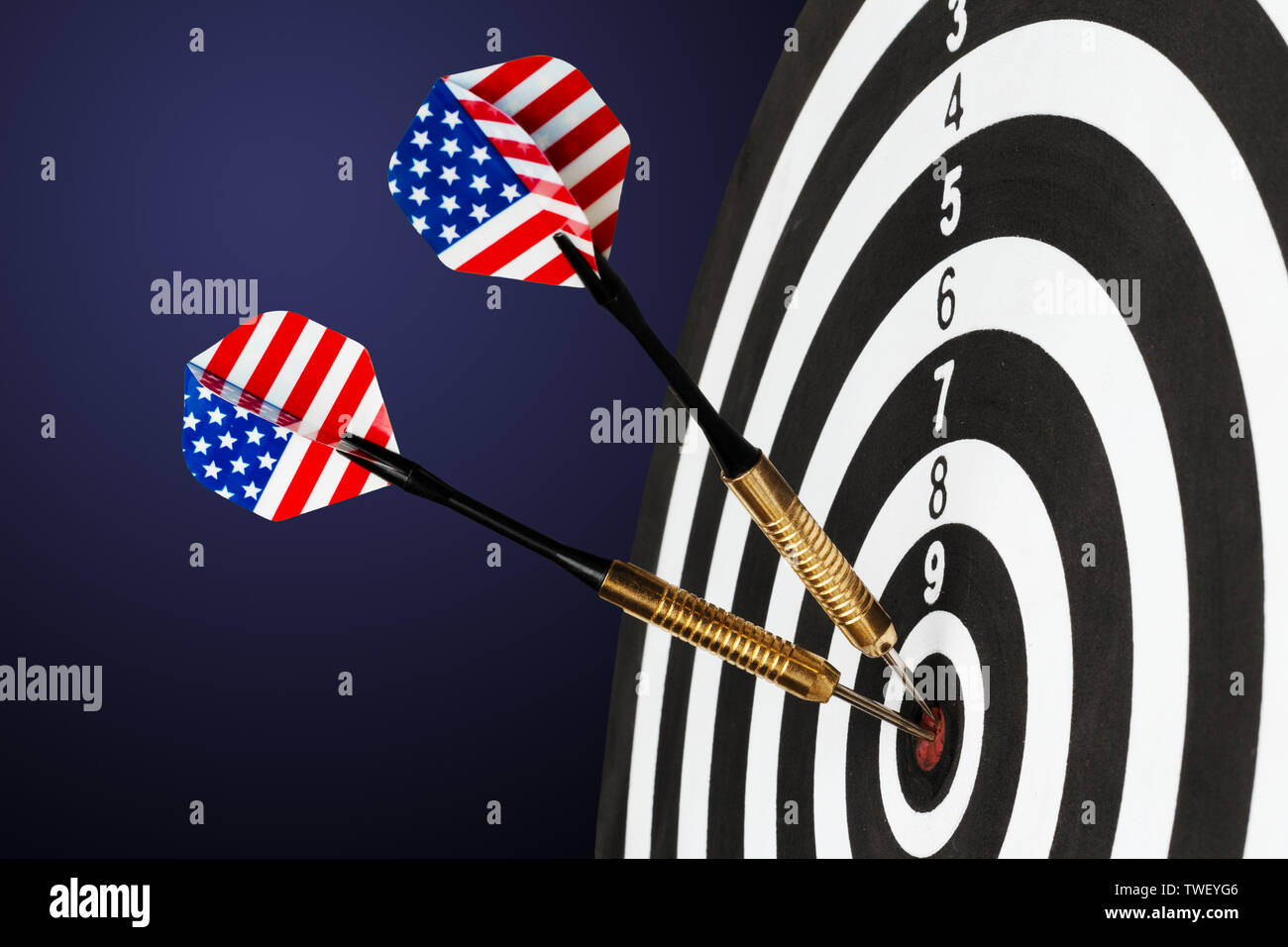dart arrow hitting in the target center of dartboard Stock Photo - Alamy