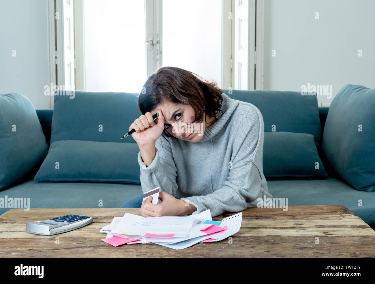 Family sitting on couch paying bills hi-res stock photography and images - Alamy