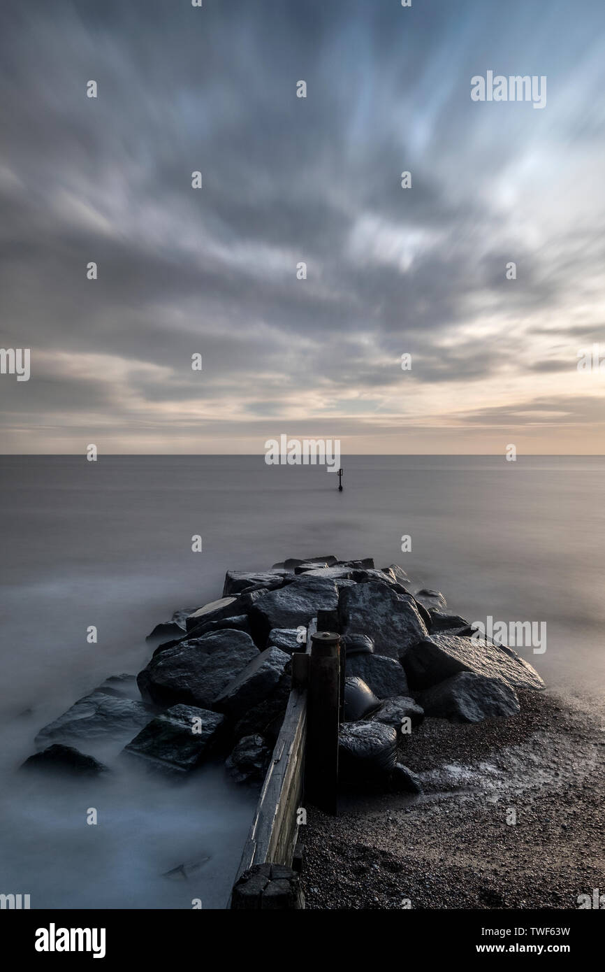 Rock groynes or sea defences to the right of Southwold pier as the sun ...