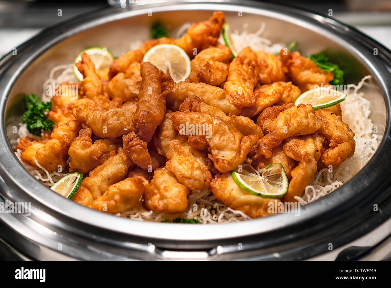 Fried dragon fish in an iron pan Stock Photo - Alamy
