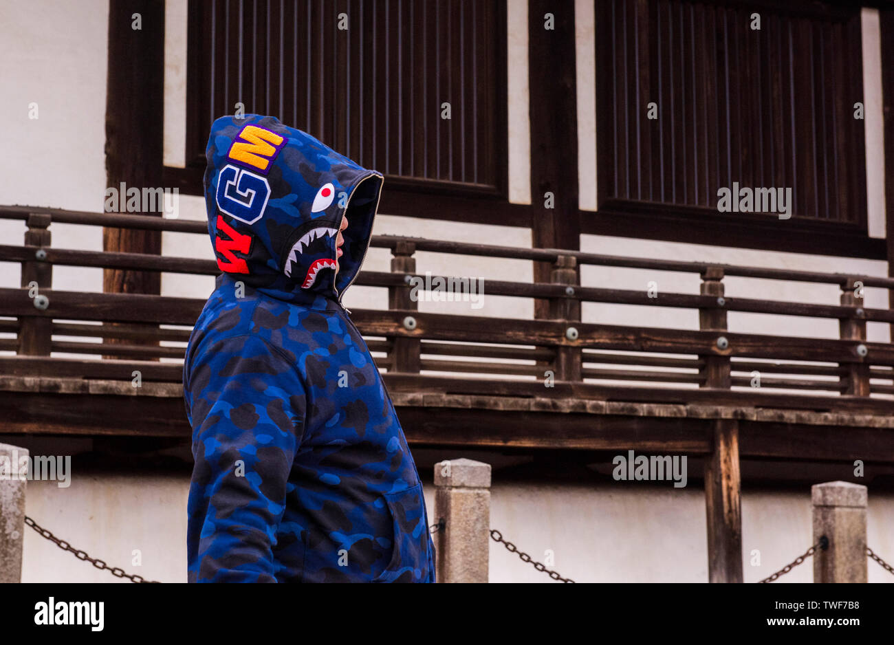 Man wearing coat with hood up while exploring Nigatsu-do Temple in Nara ...