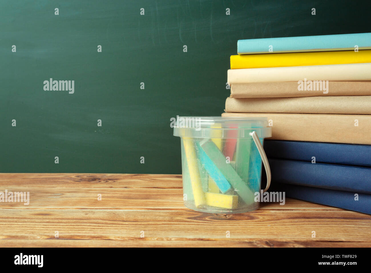 Classroom with blackboard, wooden table and books Stock Photo - Alamy
