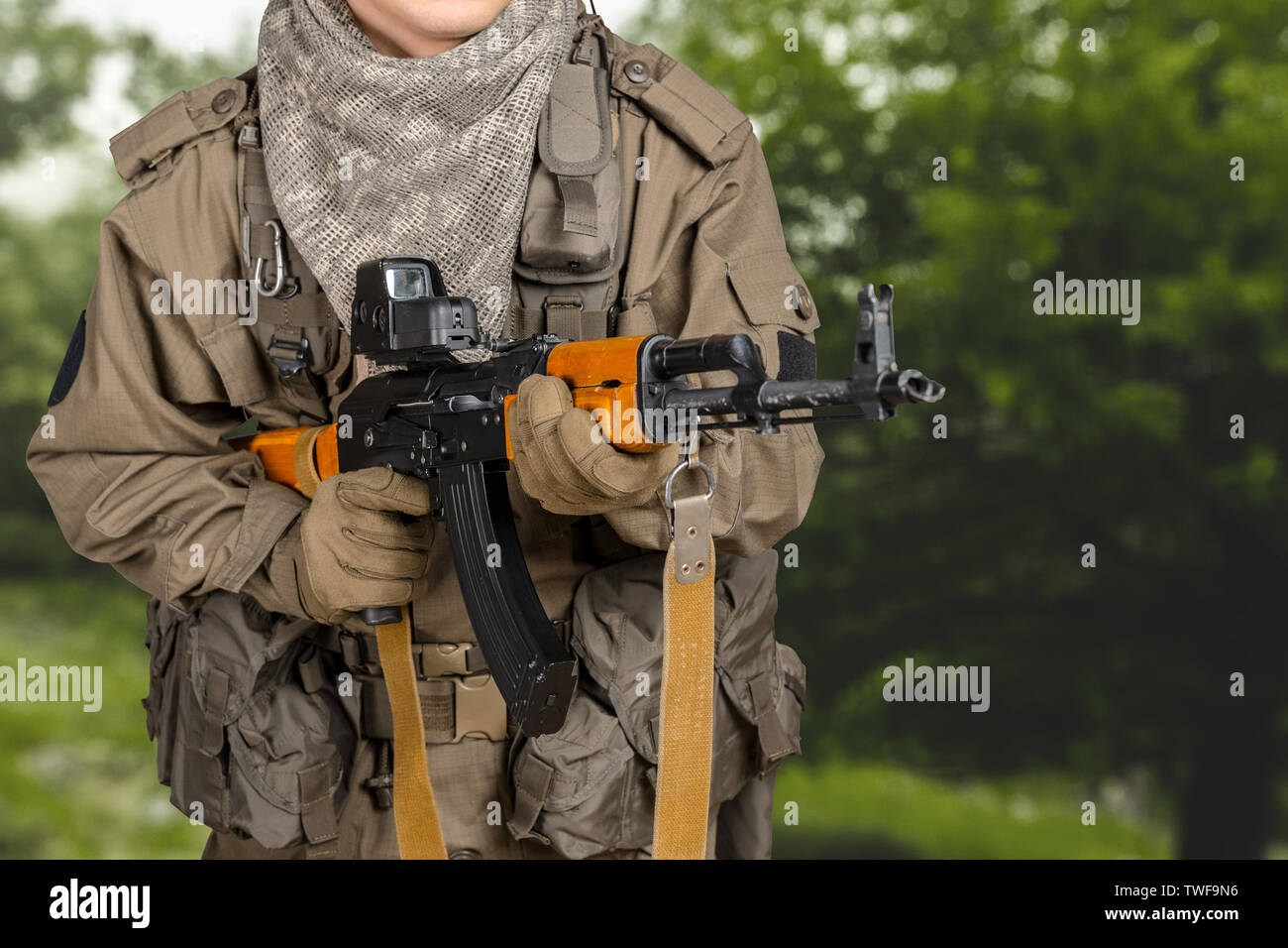 Soldier man holding his gun Stock Photo - Alamy