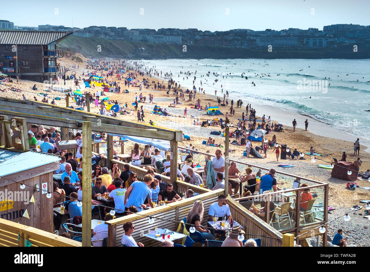Holidaymakers enjoying the sunshine on a busy Fistral Beach in Newquay ...