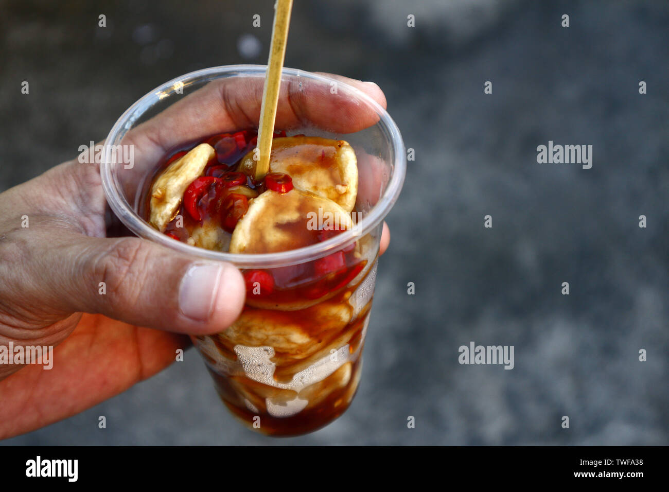 Photo of deep fried fish balls and spicy sweet sauce in a plastic cup ...
