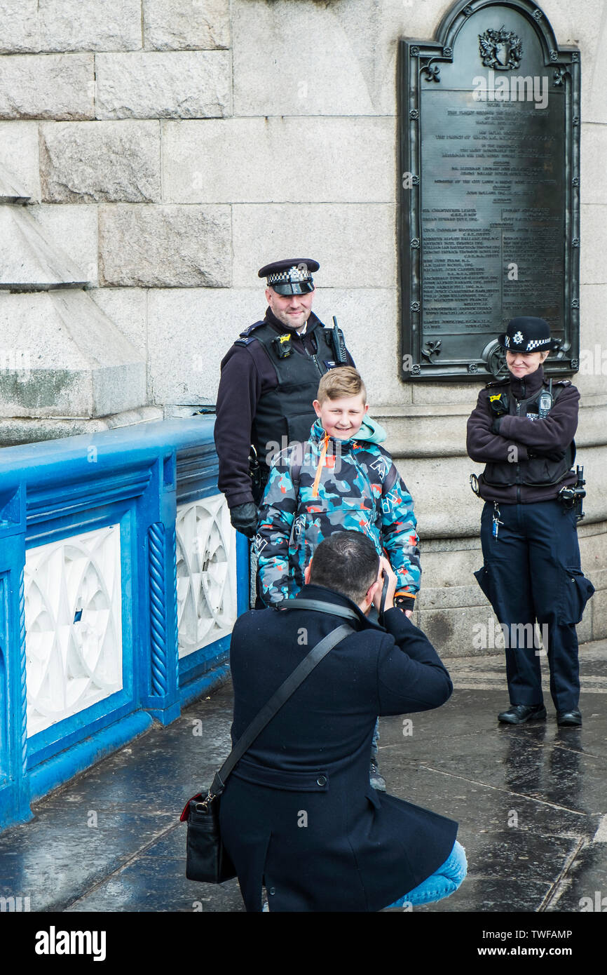 A father taking a photograph of his young son and two Metropolitan ...
