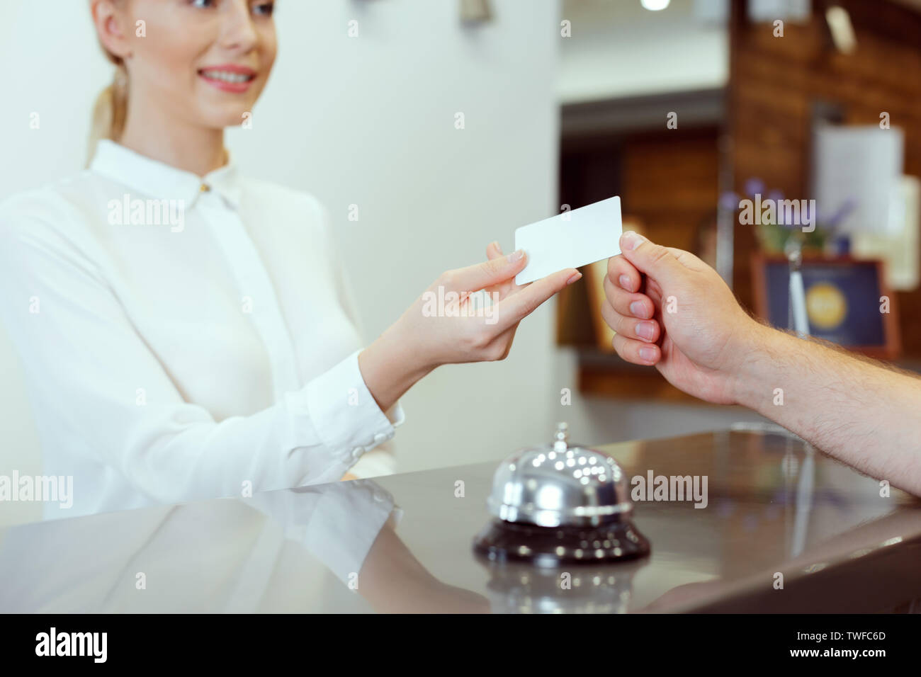 receptionist giving key Stock Photo - Alamy