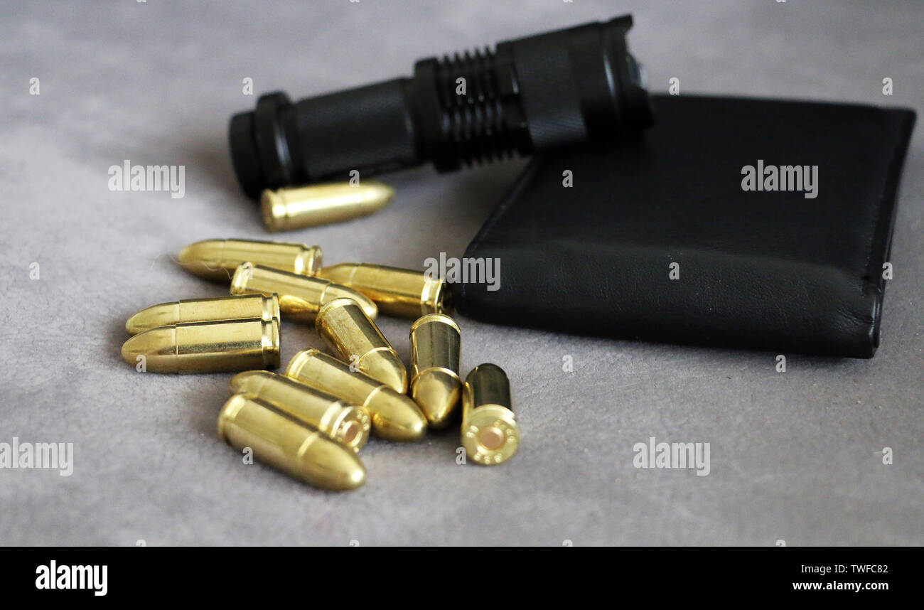 Tactical flashlight, pistol bullets and wallet Stock Photo - Alamy
