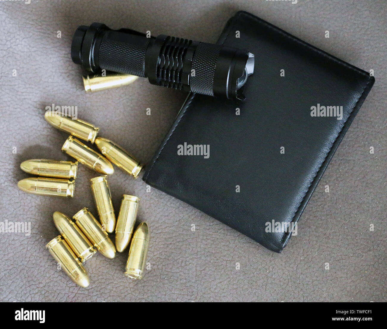 Tactical flashlight pistol bullets and wallet Stock Photo - Alamy