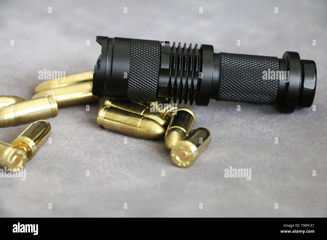Tactical flashlight and pistol bullets Stock Photo - Alamy