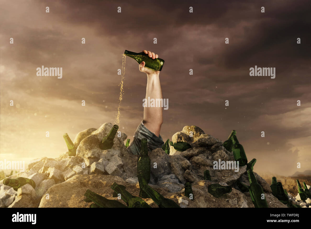 hand with green beer bottle raising up from rubbish dump and empty it ...