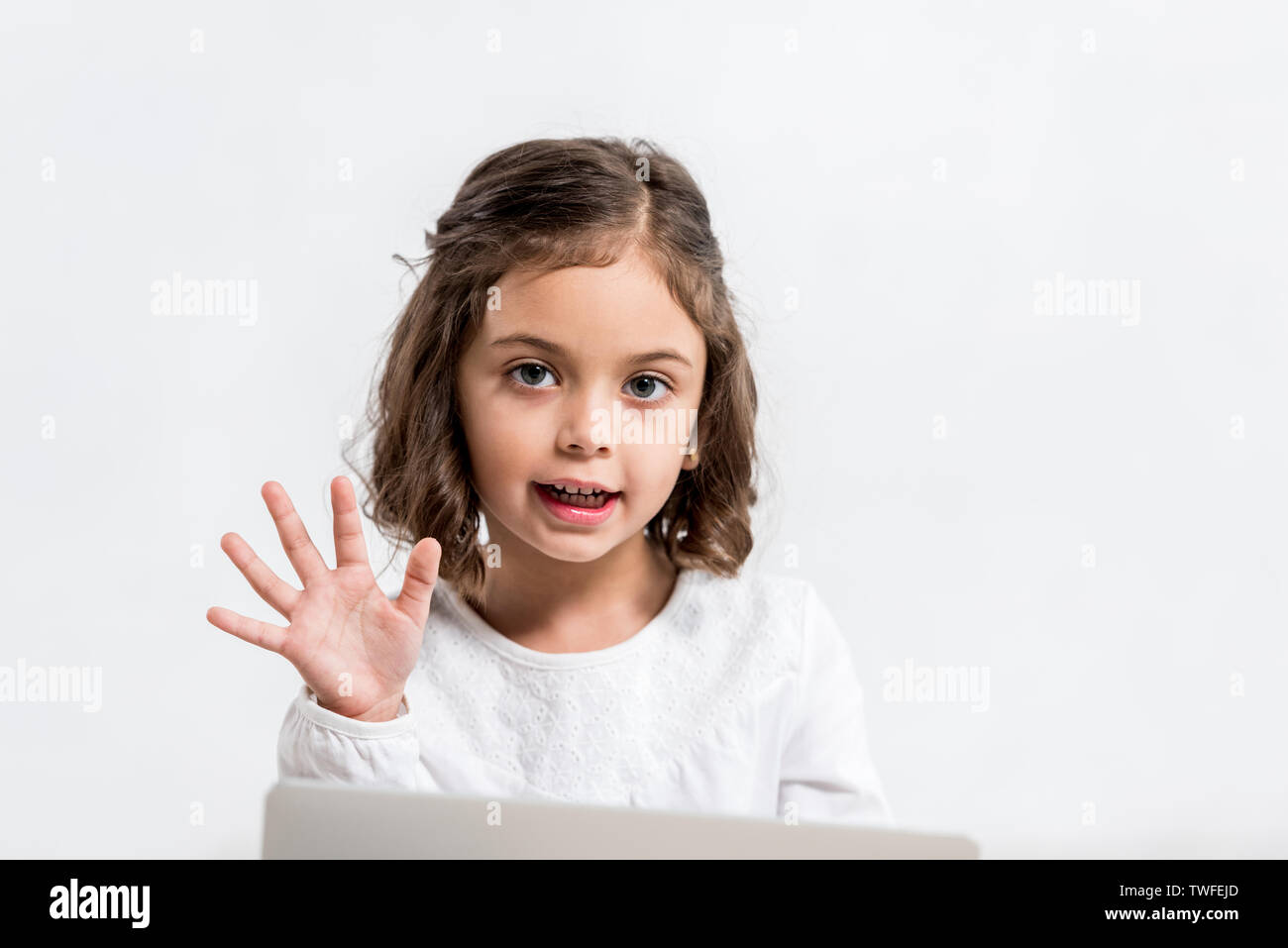 Funny preschooler kid waving hand and looking at camera isolated on ...