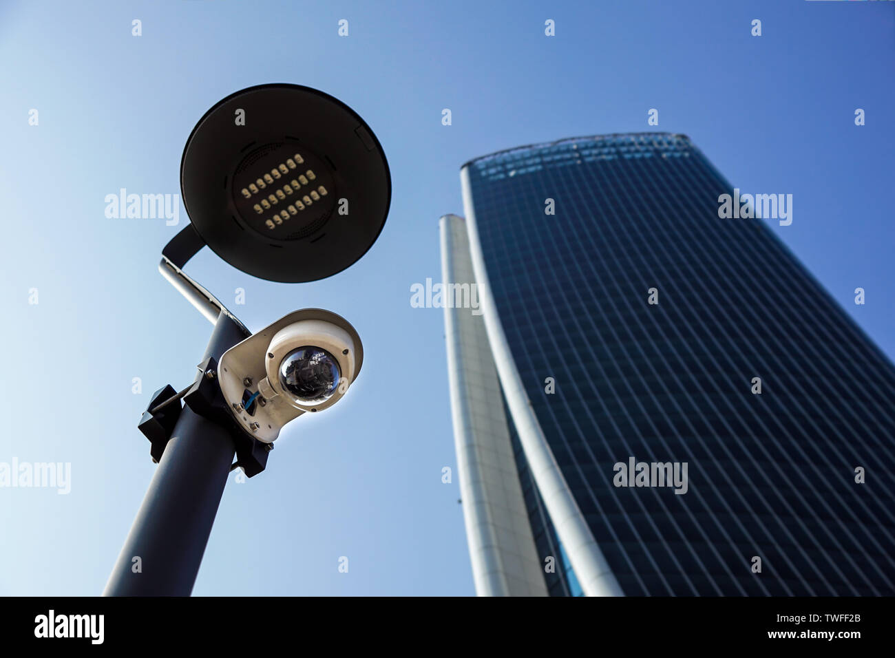 MILAN, ITALY 4 MAY 2019. Camera system guarding blue skyscraper office ...