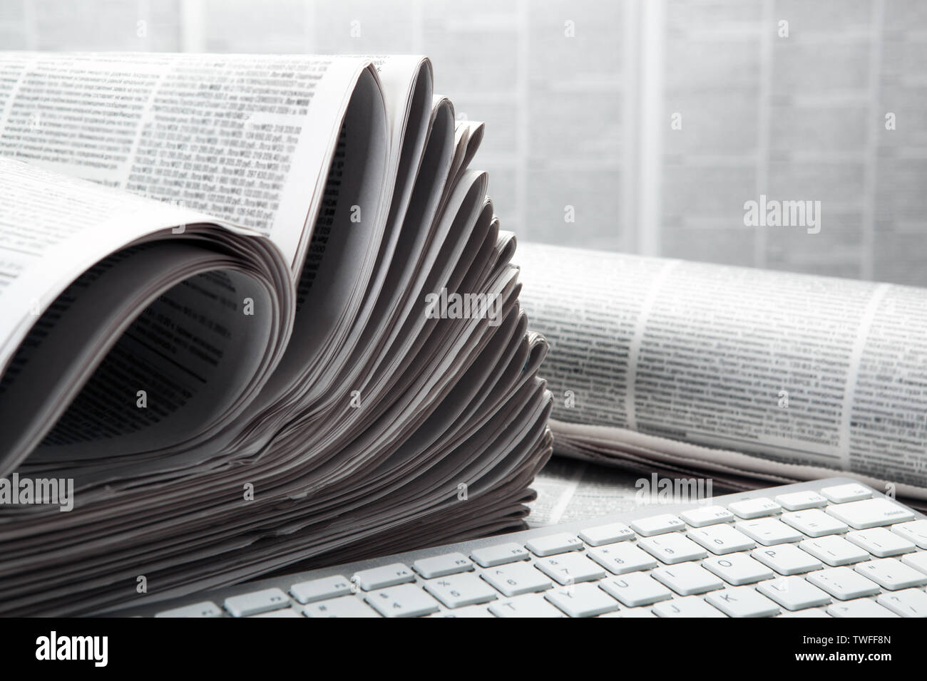 keyboard pc and piles of numerous printed newspapers closeup Stock ...