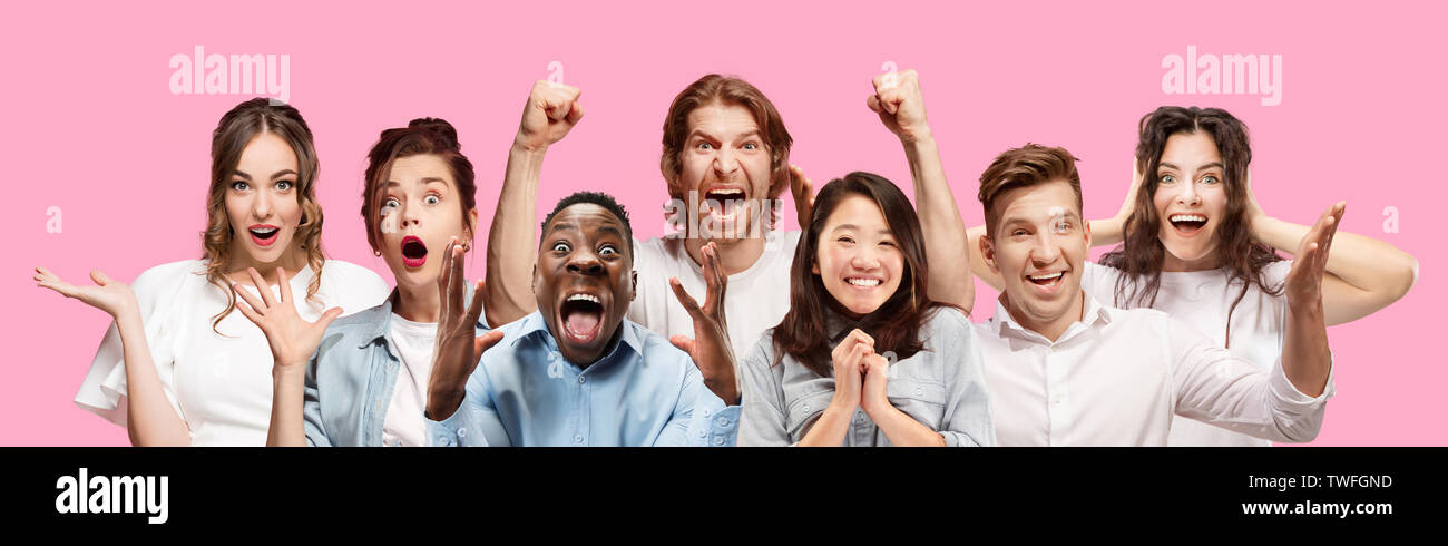 Half-length close up portrait of young people on pink background. The ...