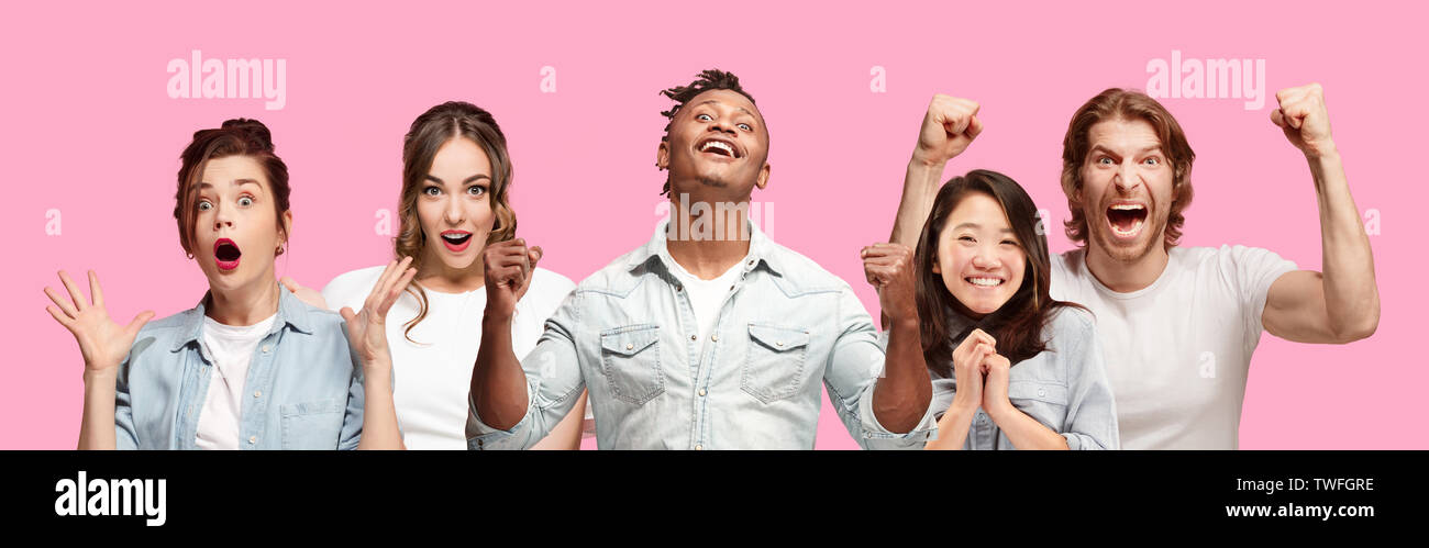 Half-length close up portrait of young people on pink background. The ...