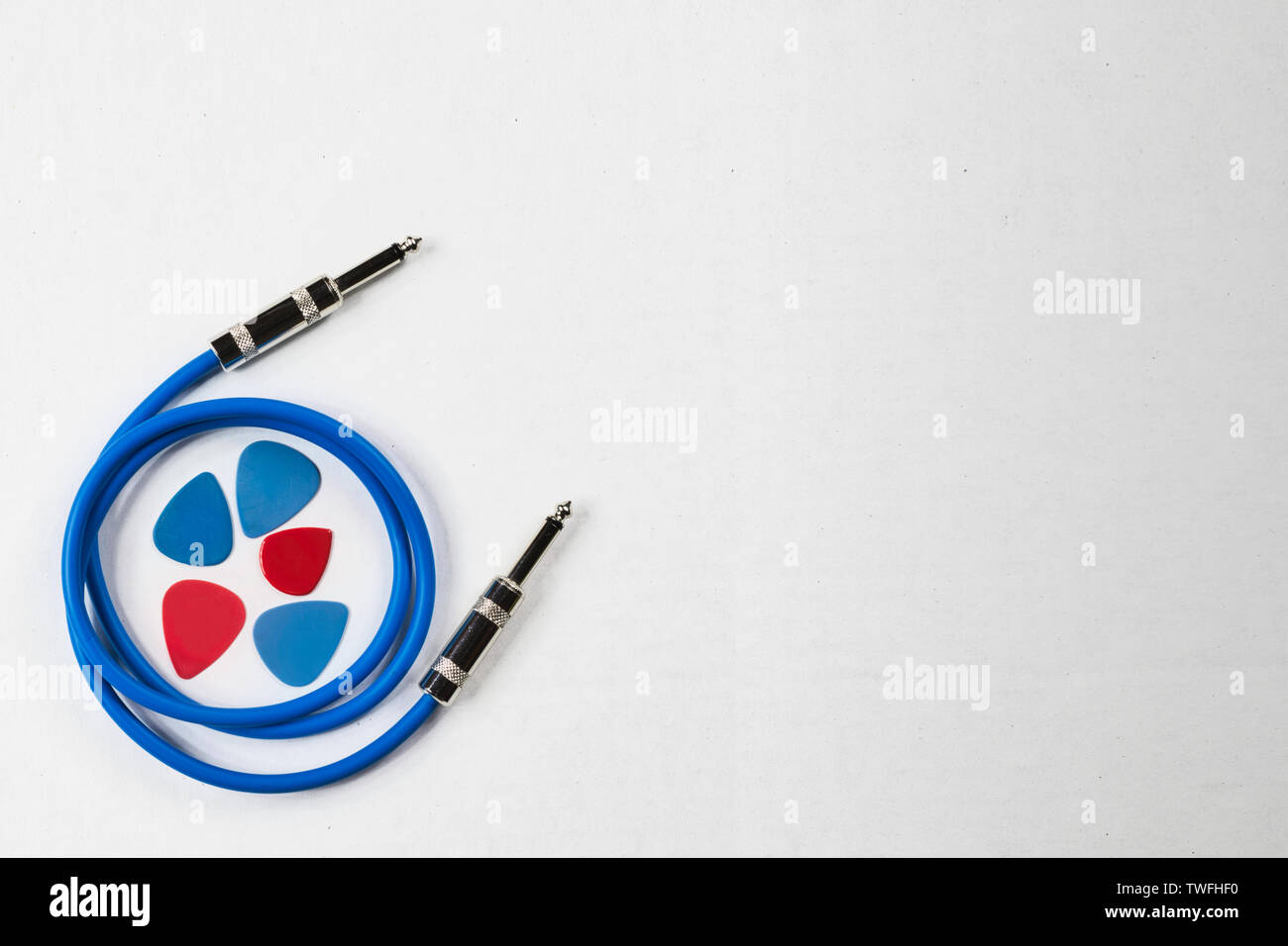 Blue Guitar patch cable on a white background with red white and blue ...