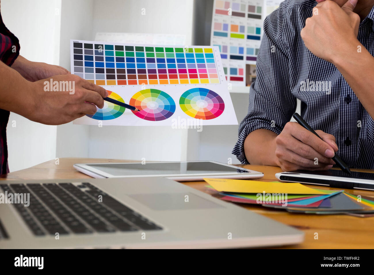 Graphic designers present colors from the color palette to their ...