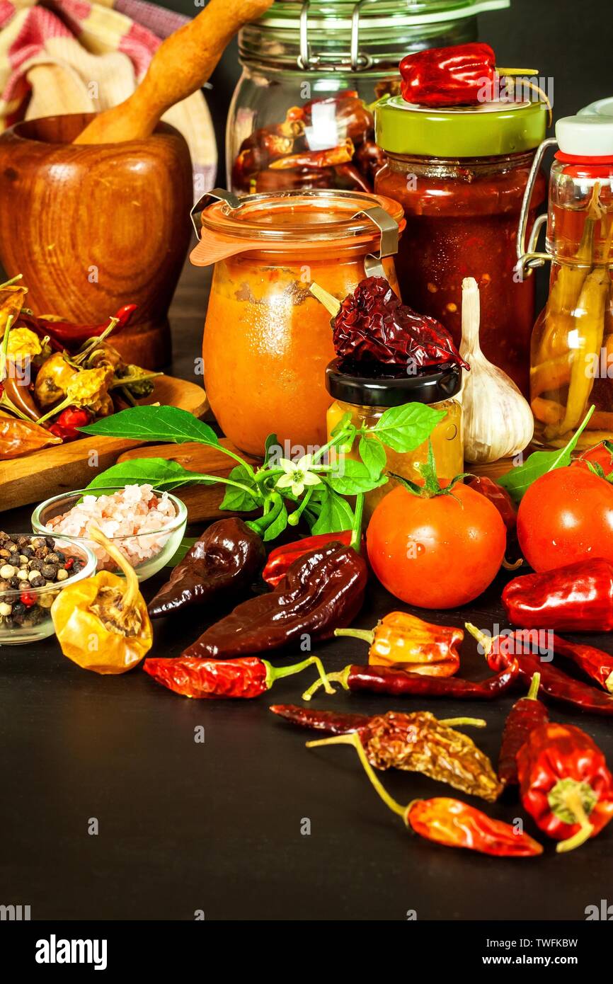 Homemade chili sauce. Spicy food. Chili peppers on black background ...