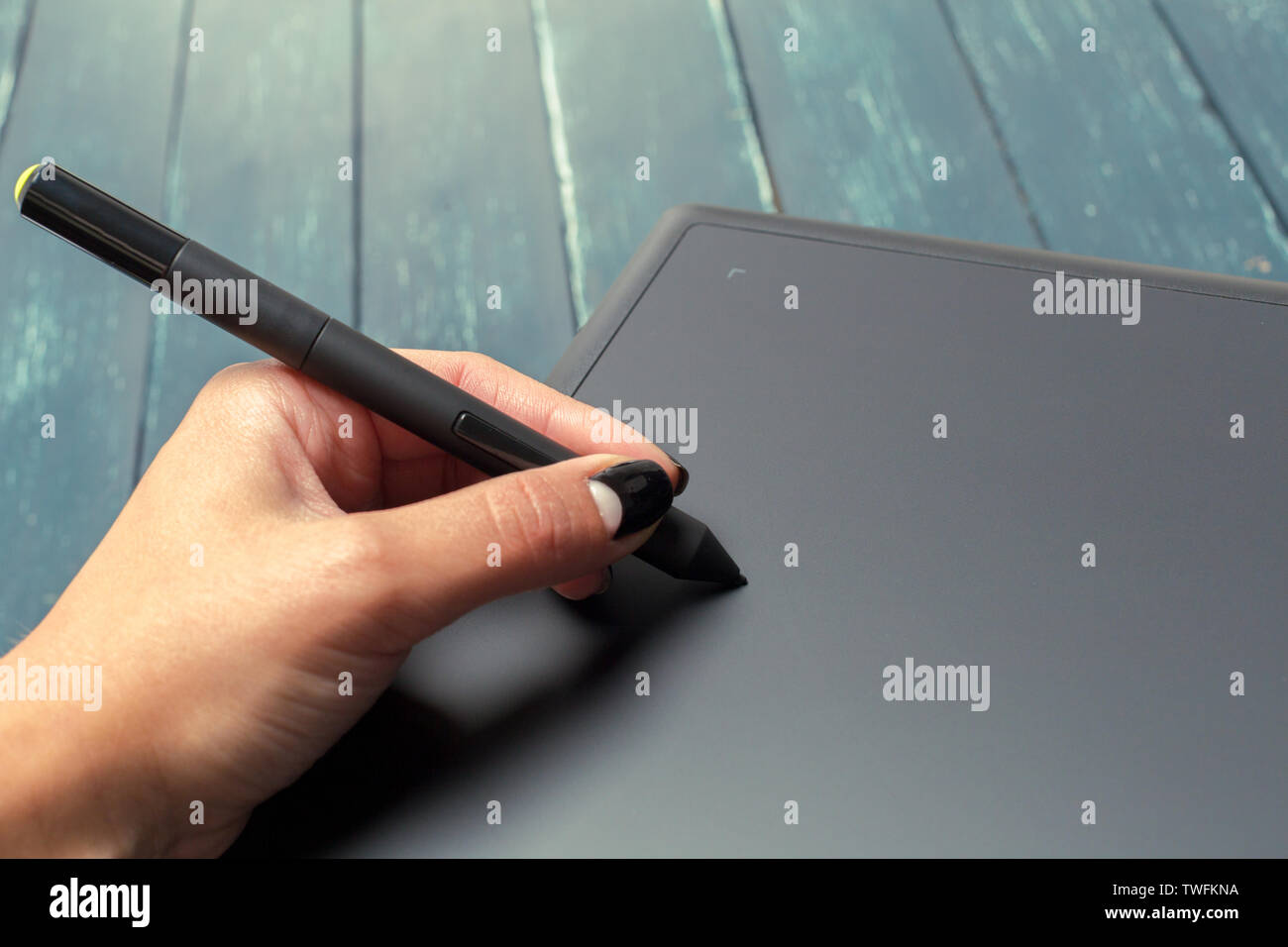 Hand of graphic designer working with stilus and tablet Stock Photo - Alamy