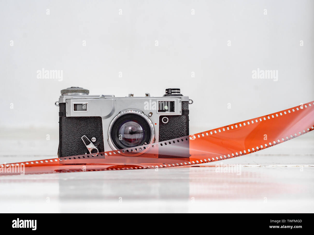 Vintage old camera with 35mm red film. Old equipment Stock Photo - Alamy