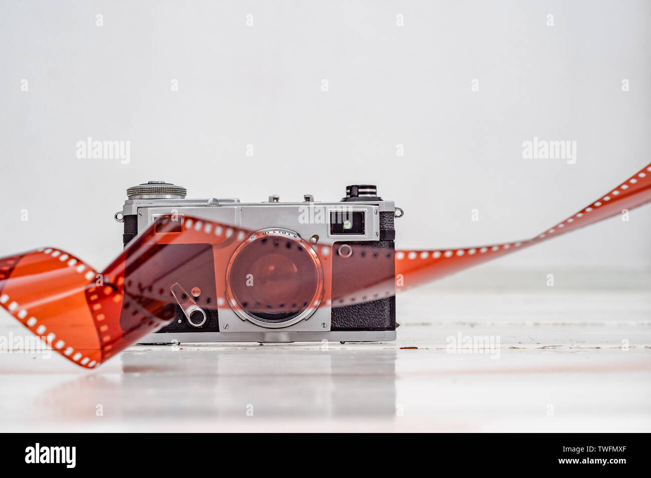 Vintage old camera with 35mm red film. Old equipment Stock Photo - Alamy