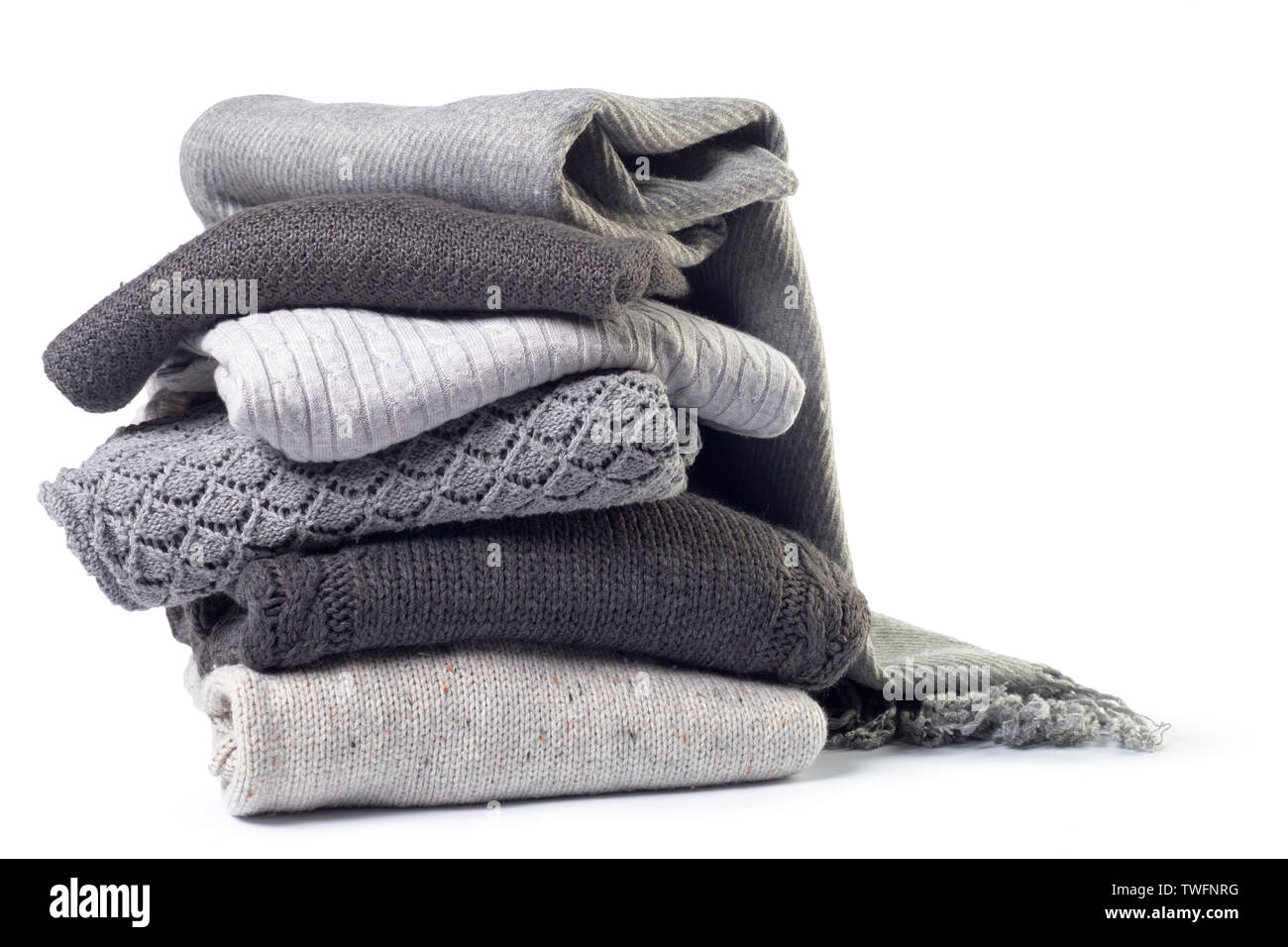 Stack of various sweaters isolated on white background Stock Photo - Alamy