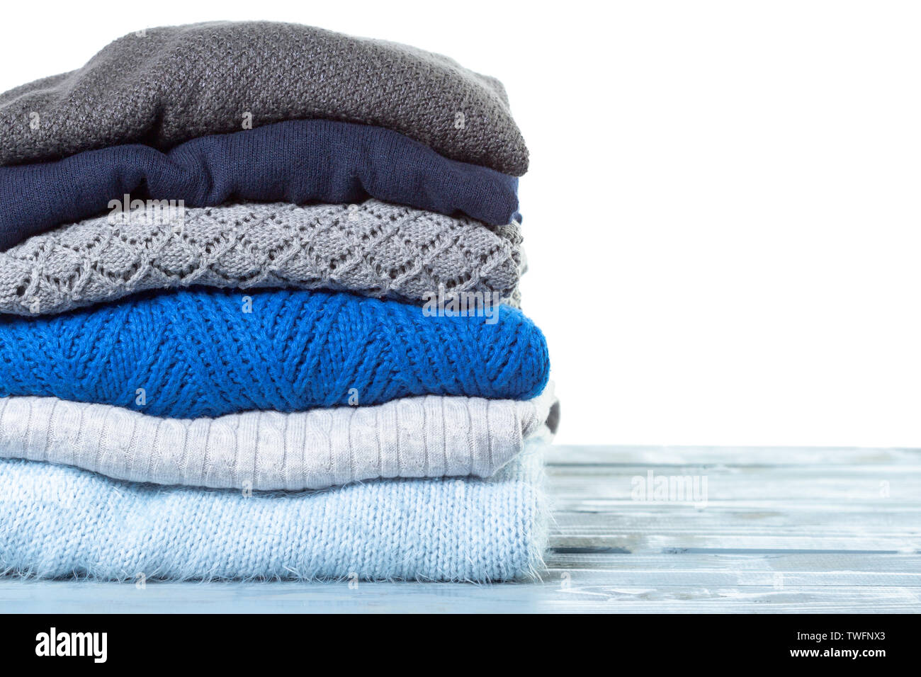 Stack of various sweaters isolated on white background Stock Photo - Alamy