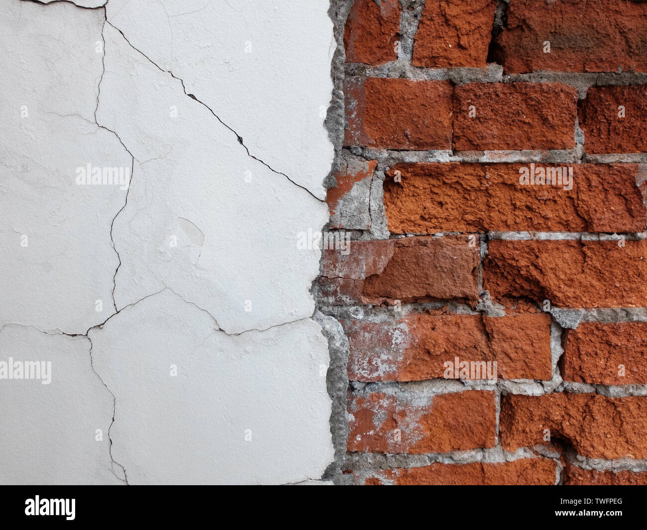 Decaying of erosion mossy red brick wall with remains of plaster of ...