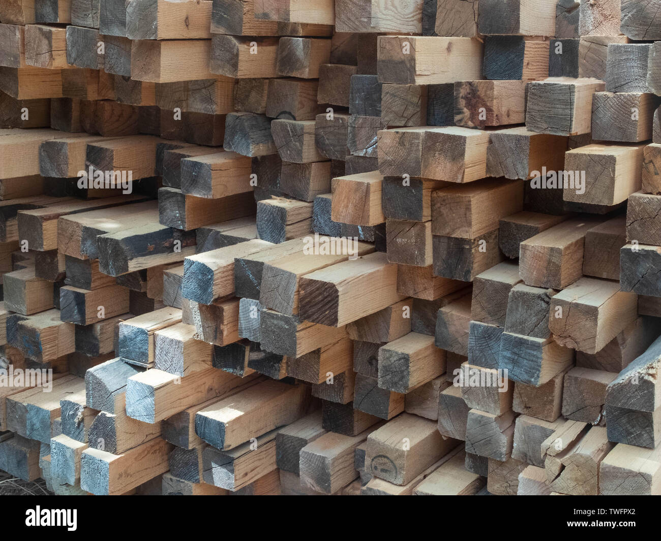 Piled wooden beams, piled lumber in the outdoor warehouse Stock Photo ...