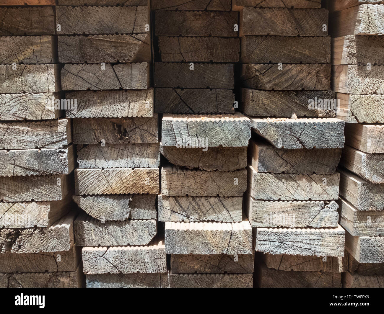 Piled wooden beams, piled lumber in the outdoor warehouse Stock Photo ...