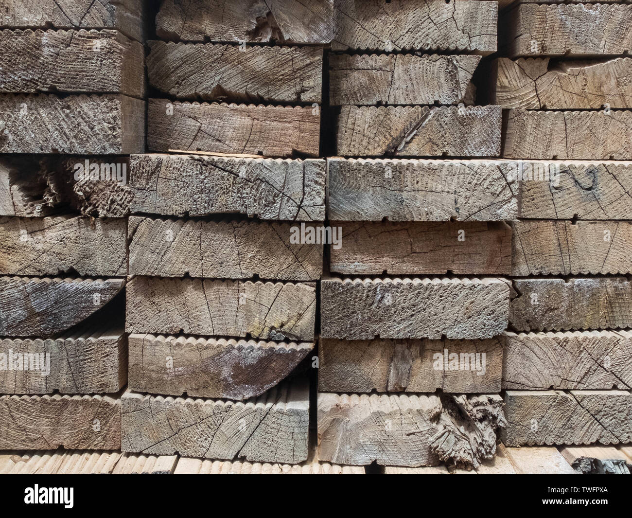 Piled wooden beams, piled lumber in the outdoor warehouse Stock Photo ...