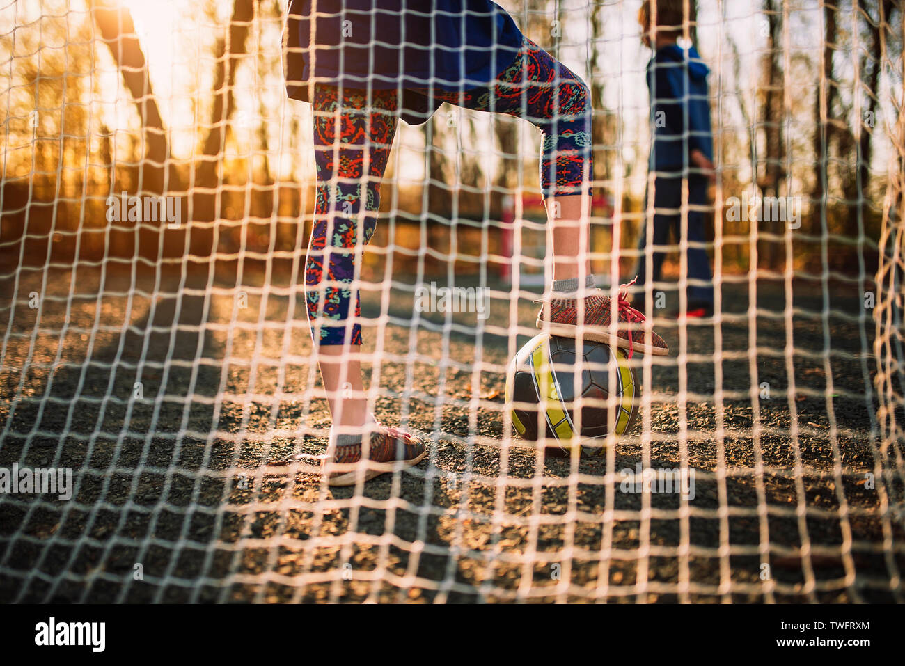 Two children playing football at sunset, United States Stock Photo - Alamy